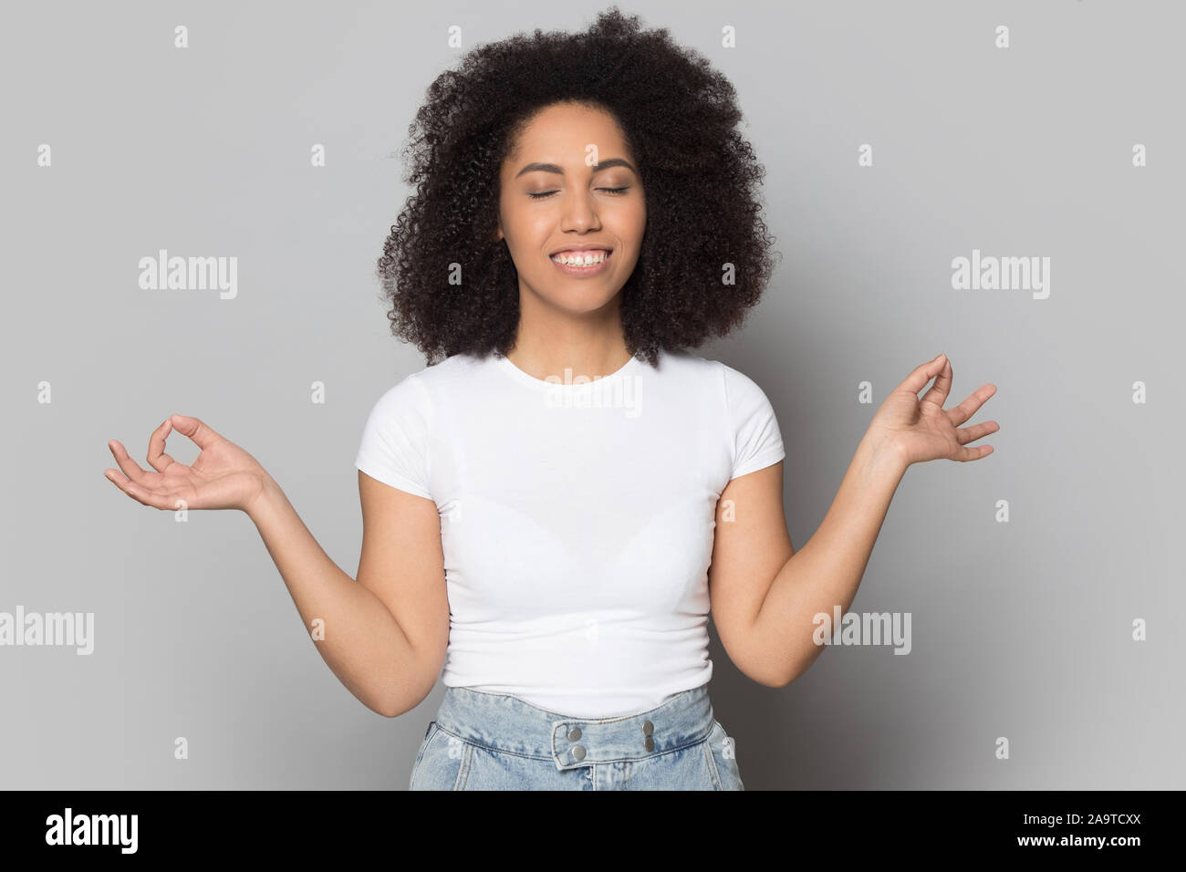 Calm relaxed African American girl with closed eyes meditating Stock ...
