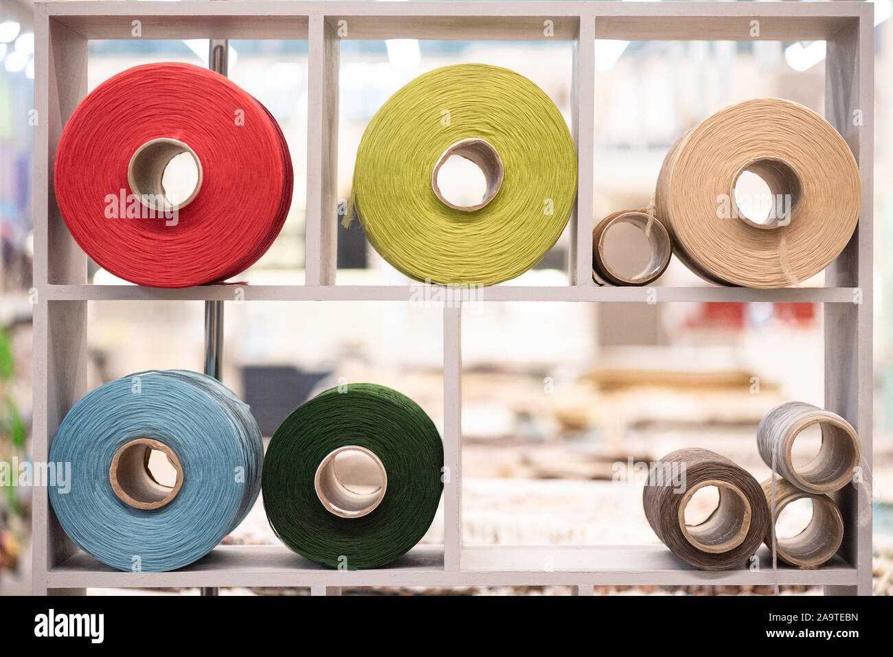 Sewing rope reels on a store shelf close up background Stock Photo - Alamy