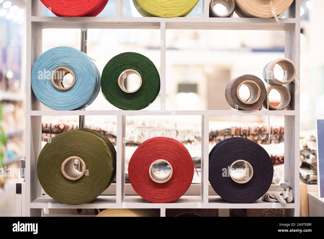 Sewing rope reels on a store shelf close up background Stock Photo - Alamy
