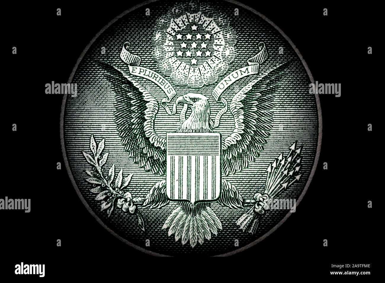 Eagle macro close-up on a US 1 dollar banknote isolated on a black ...
