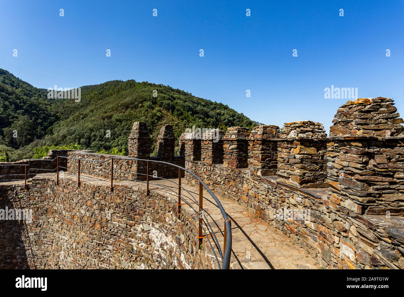 Detail of the walkway along the parapet with crenels and merlons of the ...