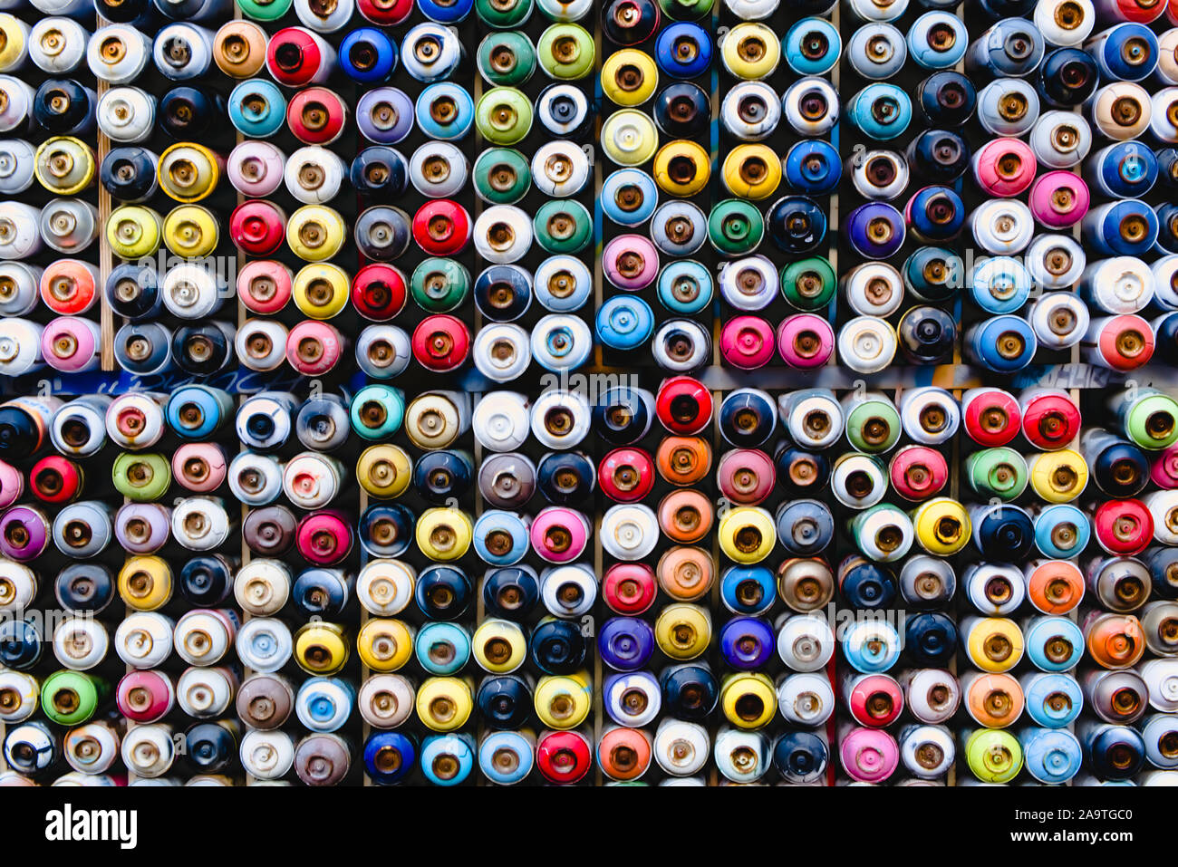 Colorful and textured background of a wall full of multicolored spray ...