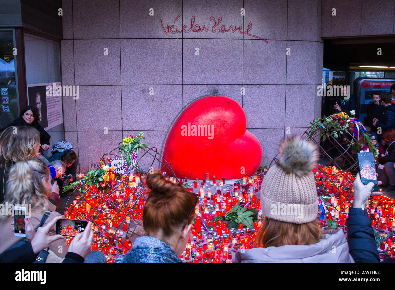 People light candles by the Vaclav Havel memorial by sculptor Kurt ...