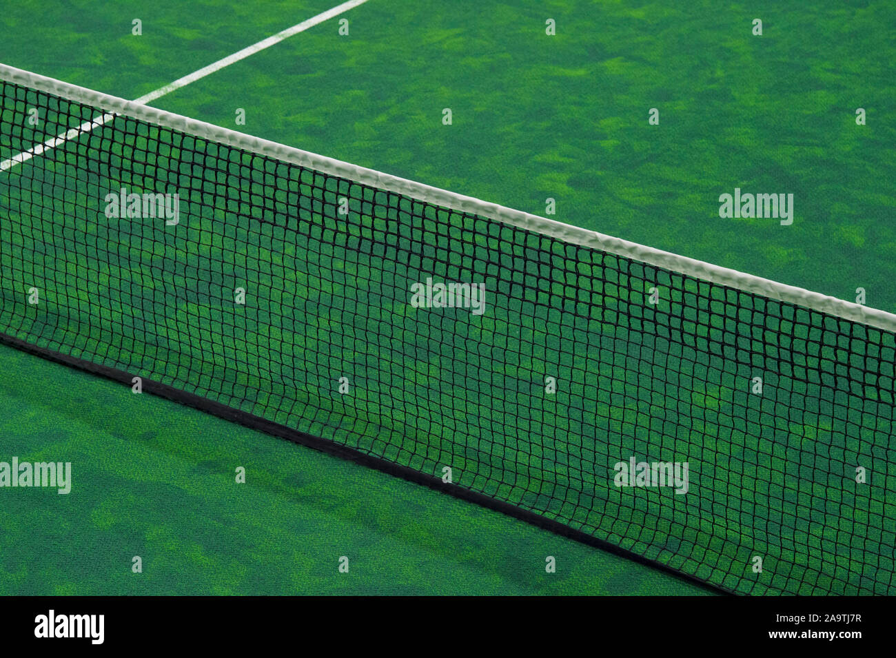 Tennis court indoor with green carpet surface Stock Photo - Alamy