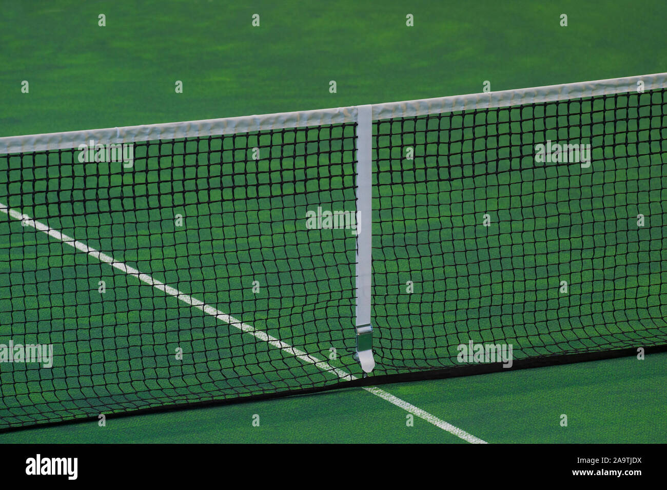 Tennis court indoor with green carpet surface Stock Photo - Alamy