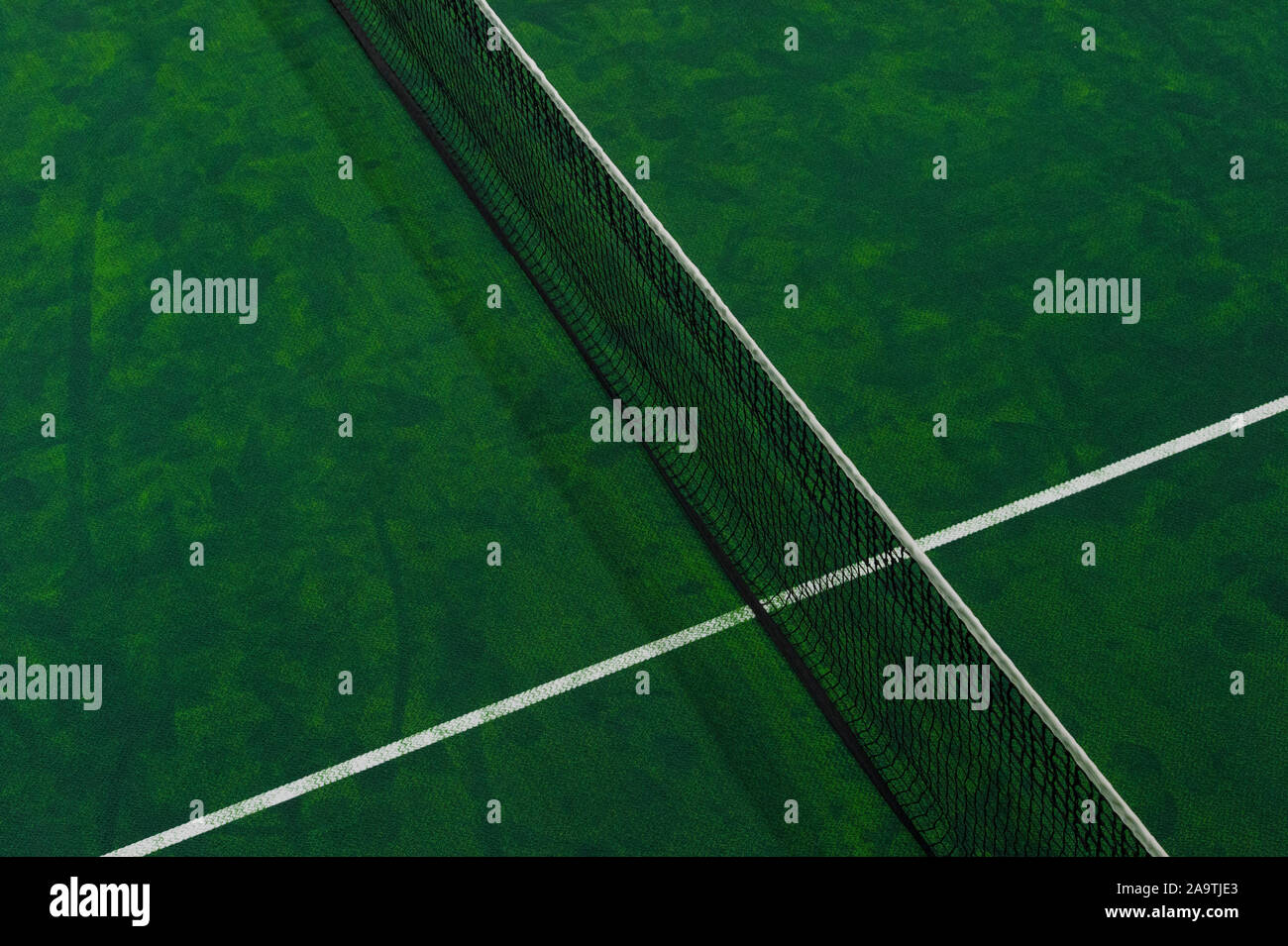 Tennis court indoor with green carpet surface Stock Photo - Alamy