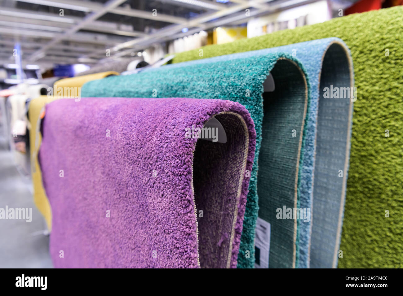 Carpets hanging on the shelves in the carpet store. different carpets ...