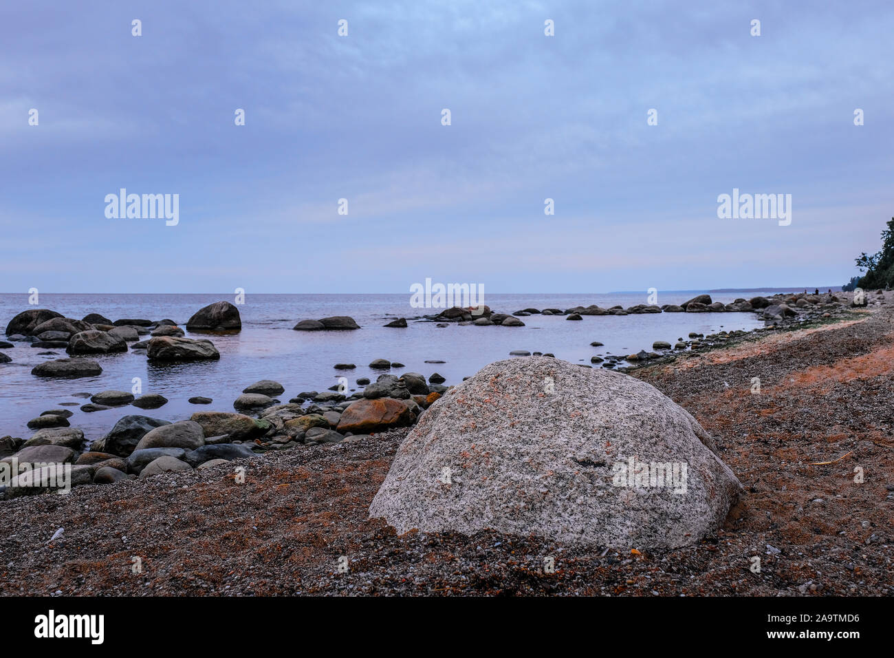 Boulders on a sea shore. Wild rocky seashore on a cloudy day. Fabulous ...
