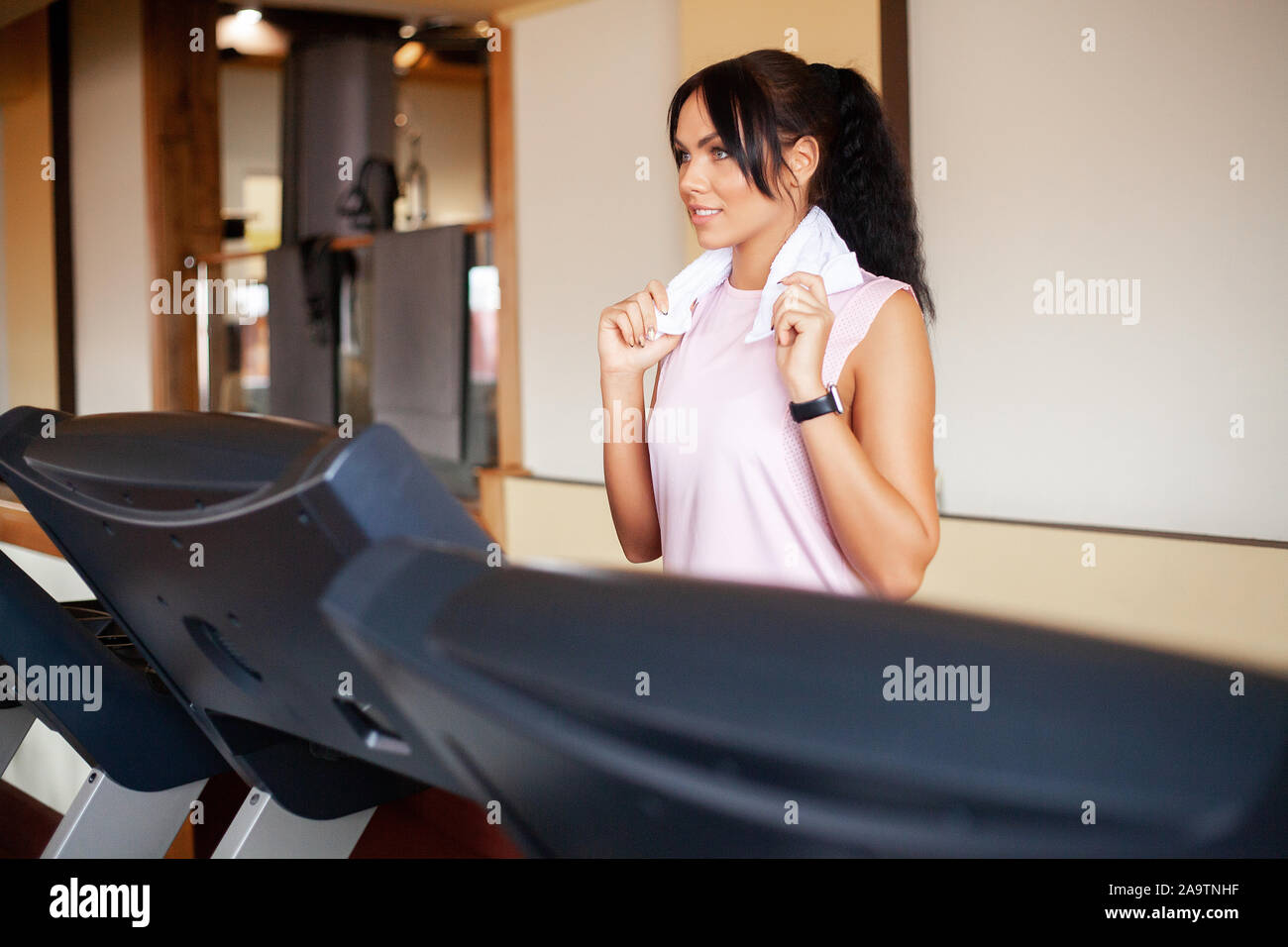 Cardio workout. Fit women running on treadmills doing cardio training ...