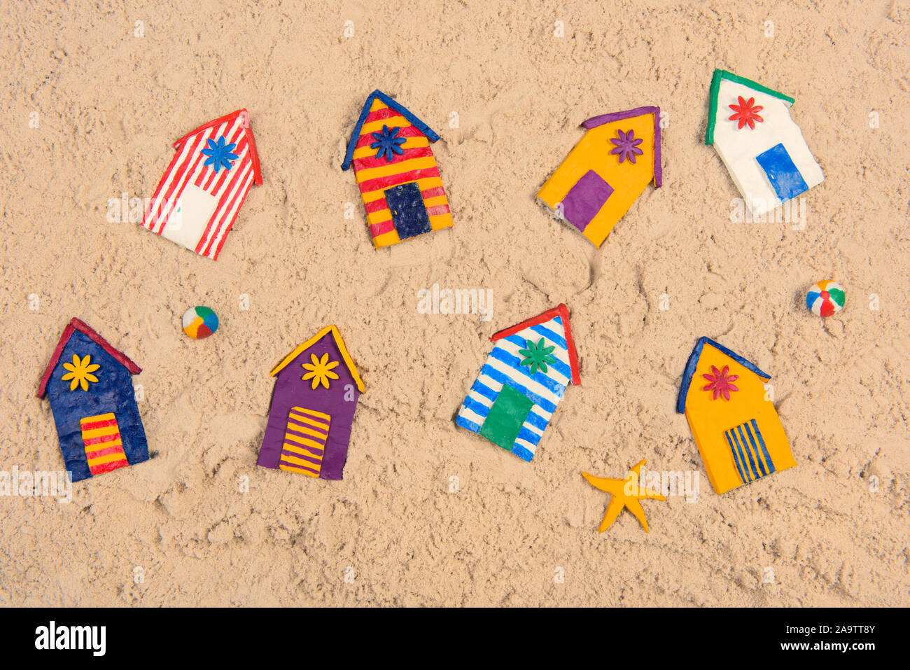 Hand made Miniature beach huts in sand Stock Photo - Alamy