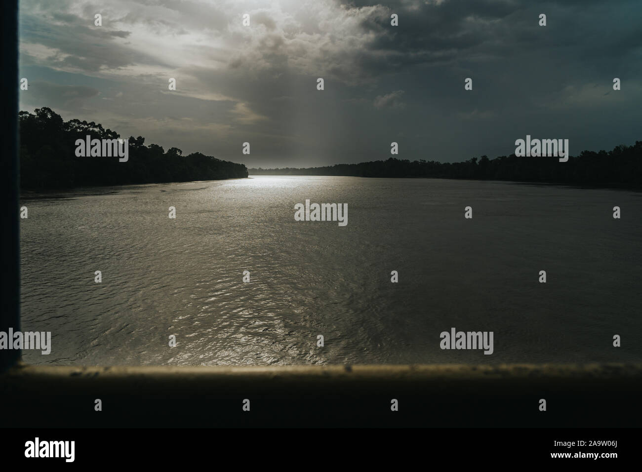 dramatic sunlight shining through clouds on the amazon river Stock ...