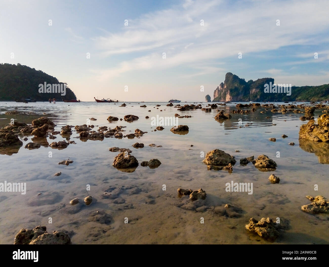 Tropical island beach at low tide landscape. The water level dropped ...