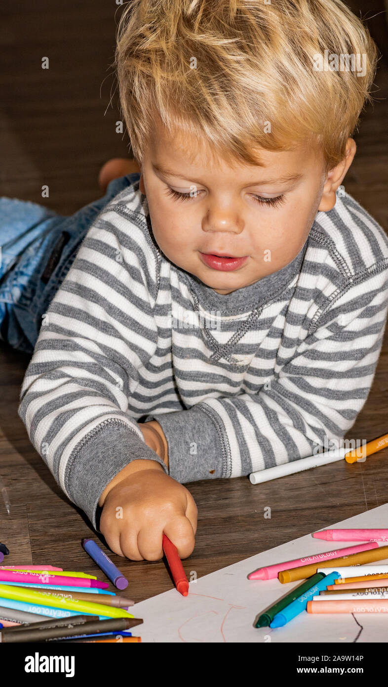 Boy Coloring With Crayons