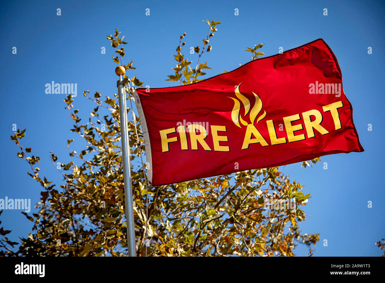 Flag with yellow letters that reads "Fire Alert Stock Photo - Alamy