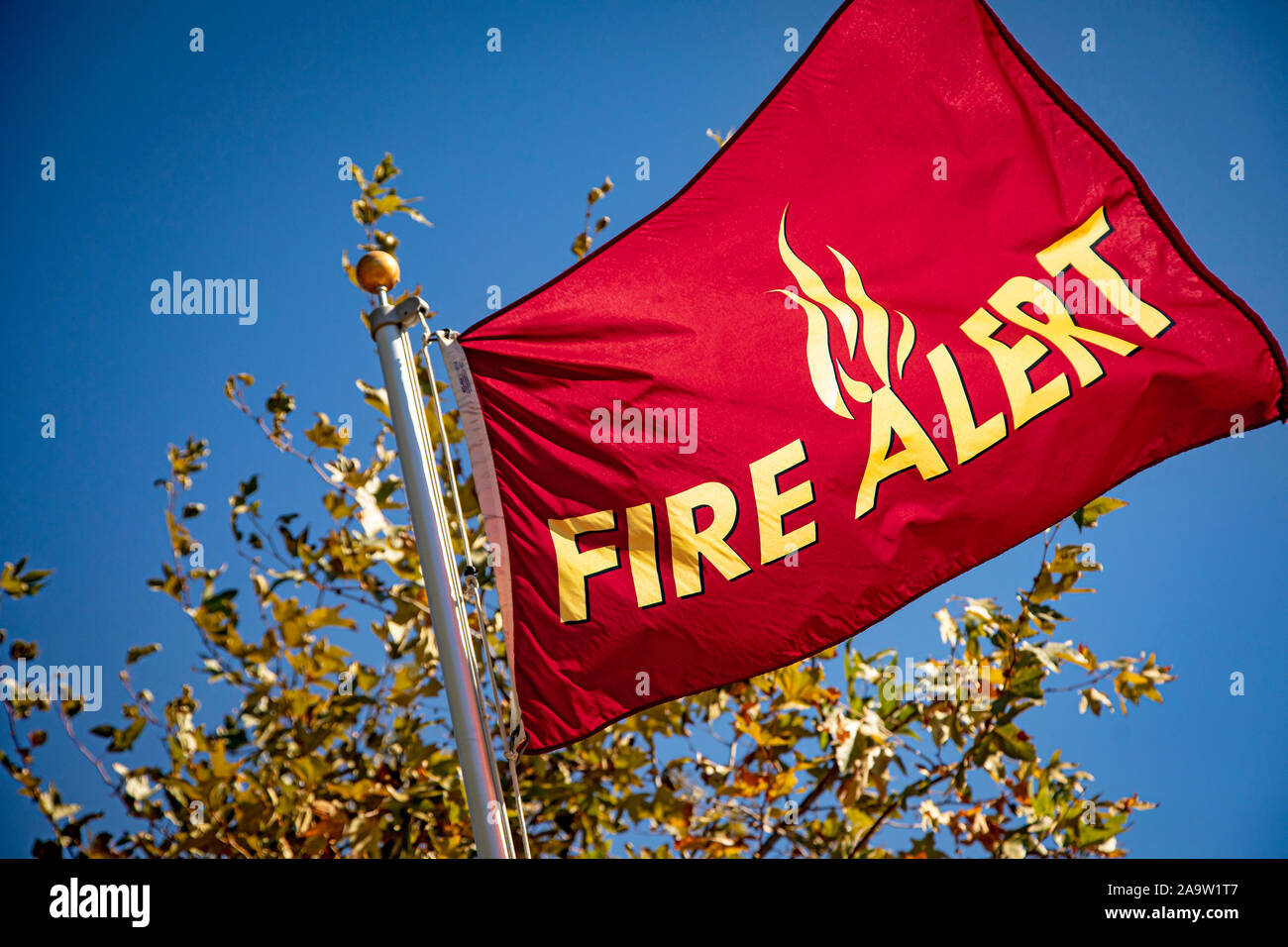 Flag with yellow letters that reads "Fire Alert Stock Photo - Alamy