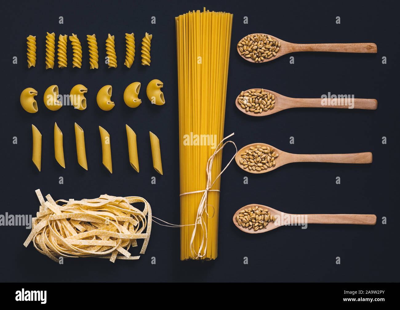 Different shapes of pasta and wheat grain on black background. Italian ...