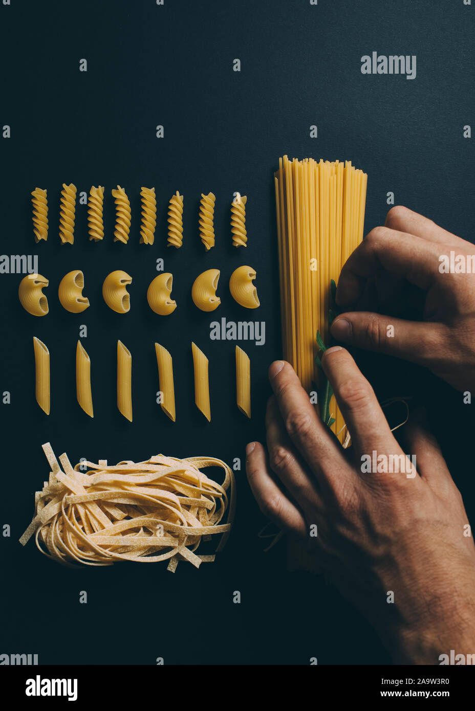 Different shapes of pasta and spaghetti on black background Stock Photo ...