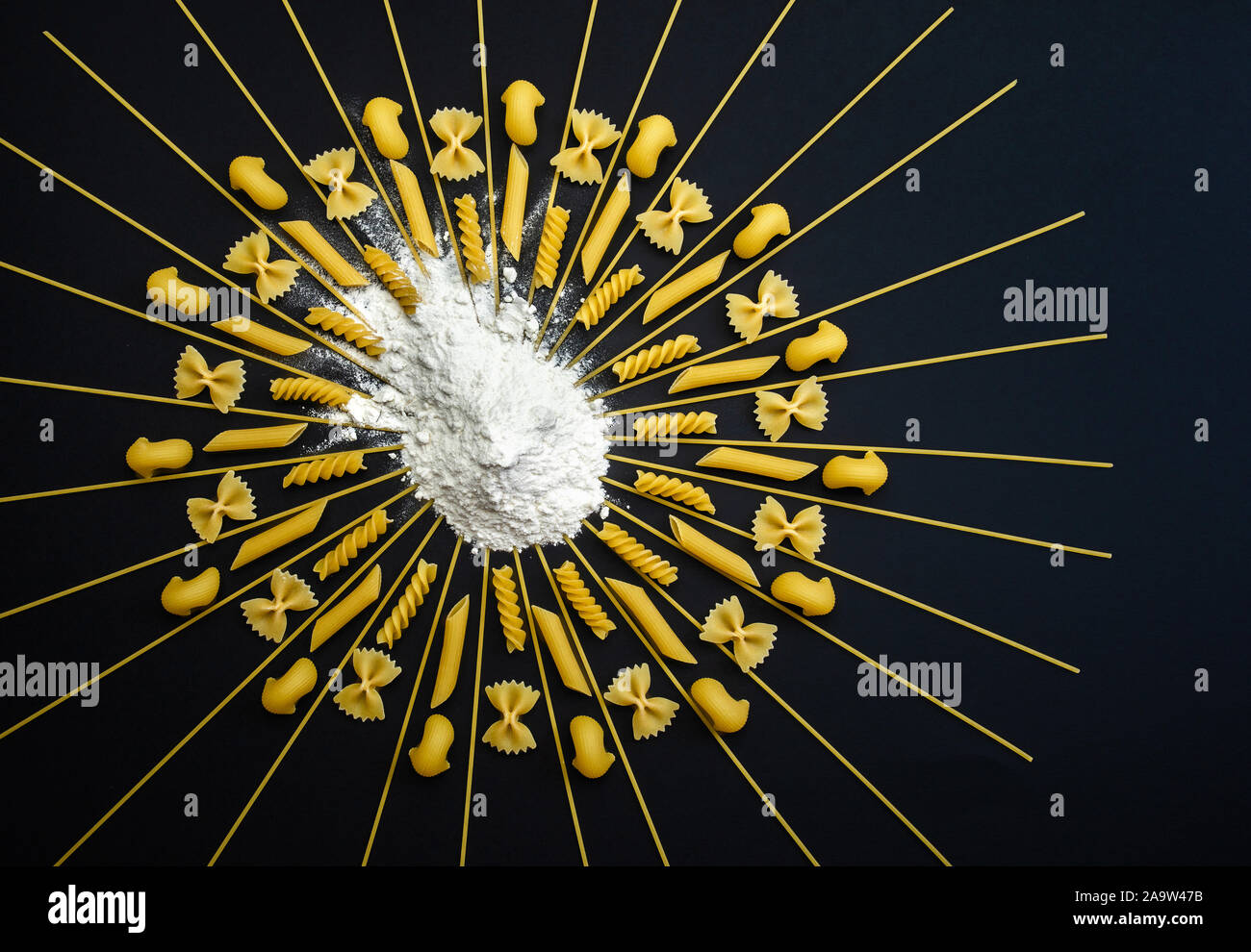 Pasta arranged around pile of flour and wheat. Geometric arranged ...