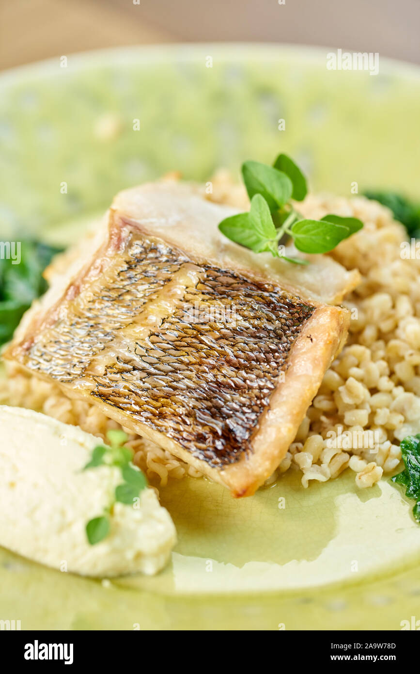 Roasted Pike perch with spelt and Polish sauce. Dish decorated with a ...