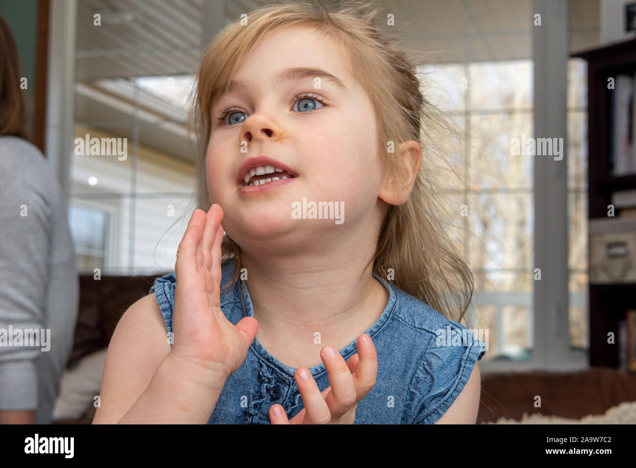 A very cute, adorable, blue eyed young girl with a very expressive face ...