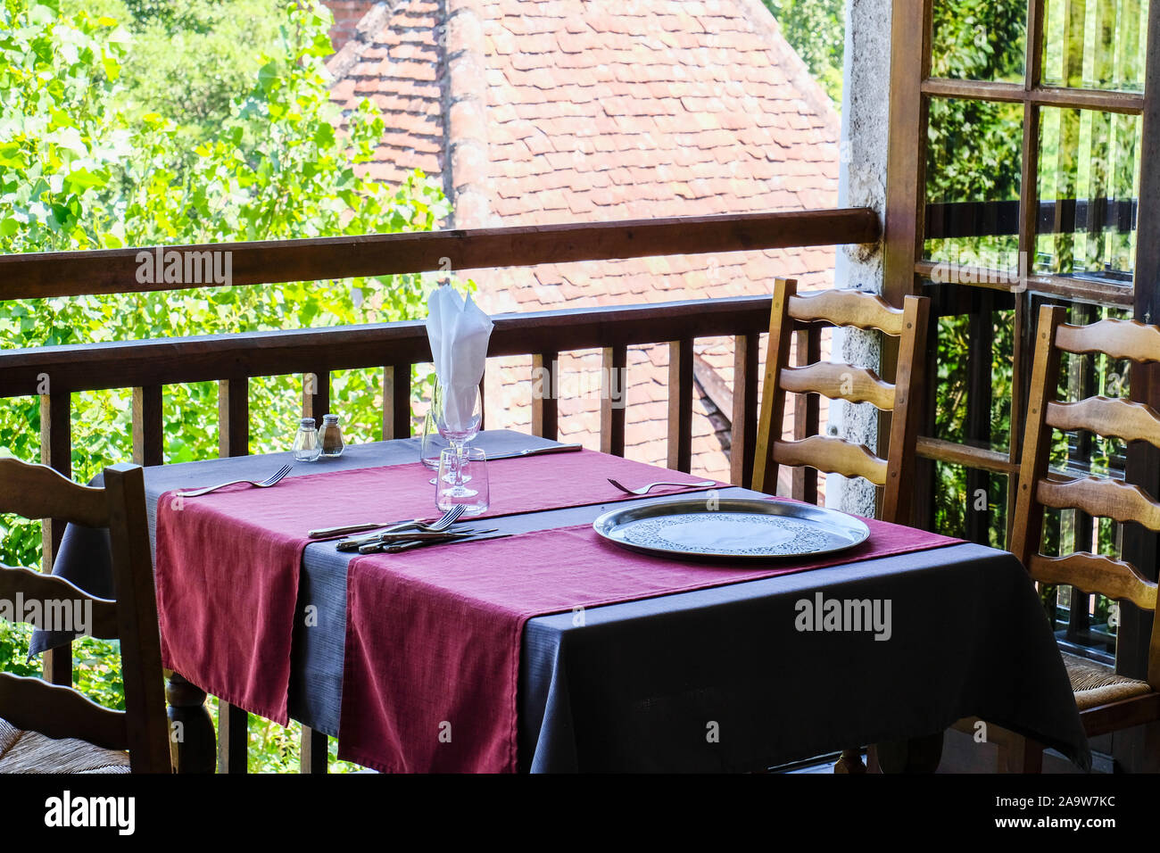 Dinning table by an open window at a restaurant at Carennace, one of ...