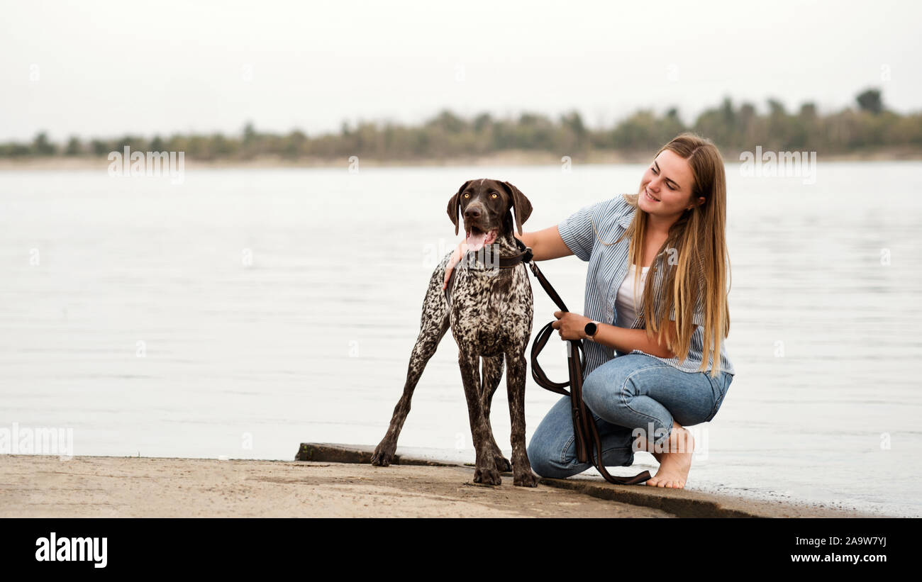 Best friends young woman and German Shorthaired Pointer sitting on by ...