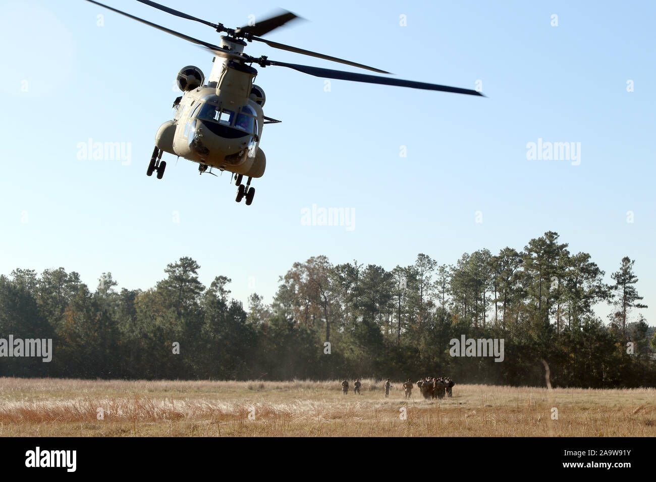 Trainees with the Recruit Sustainment Program file away from a Chinook ...