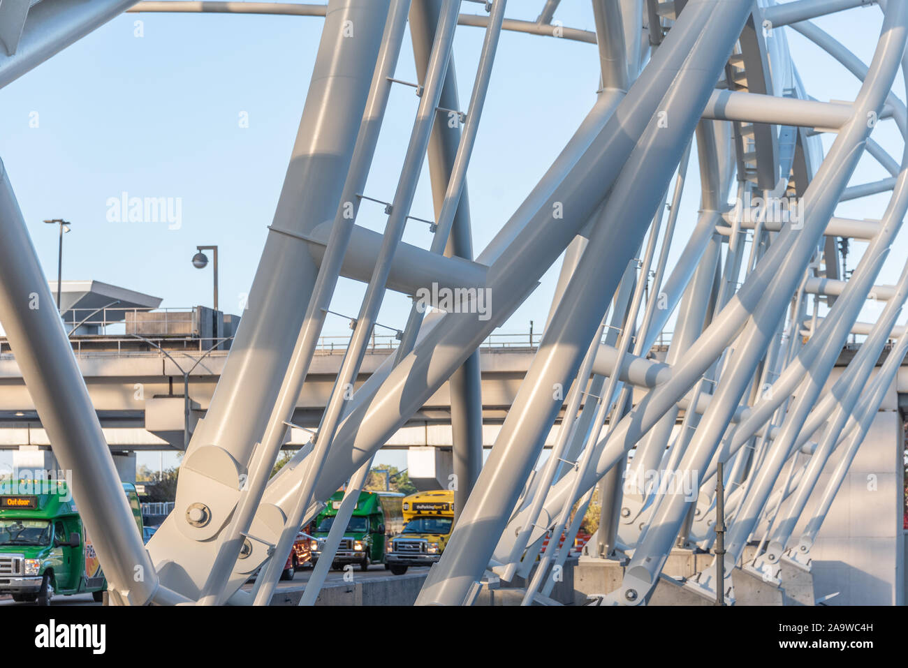 Airport shuttle vans seen through the contemporary rolled steel canopy ...