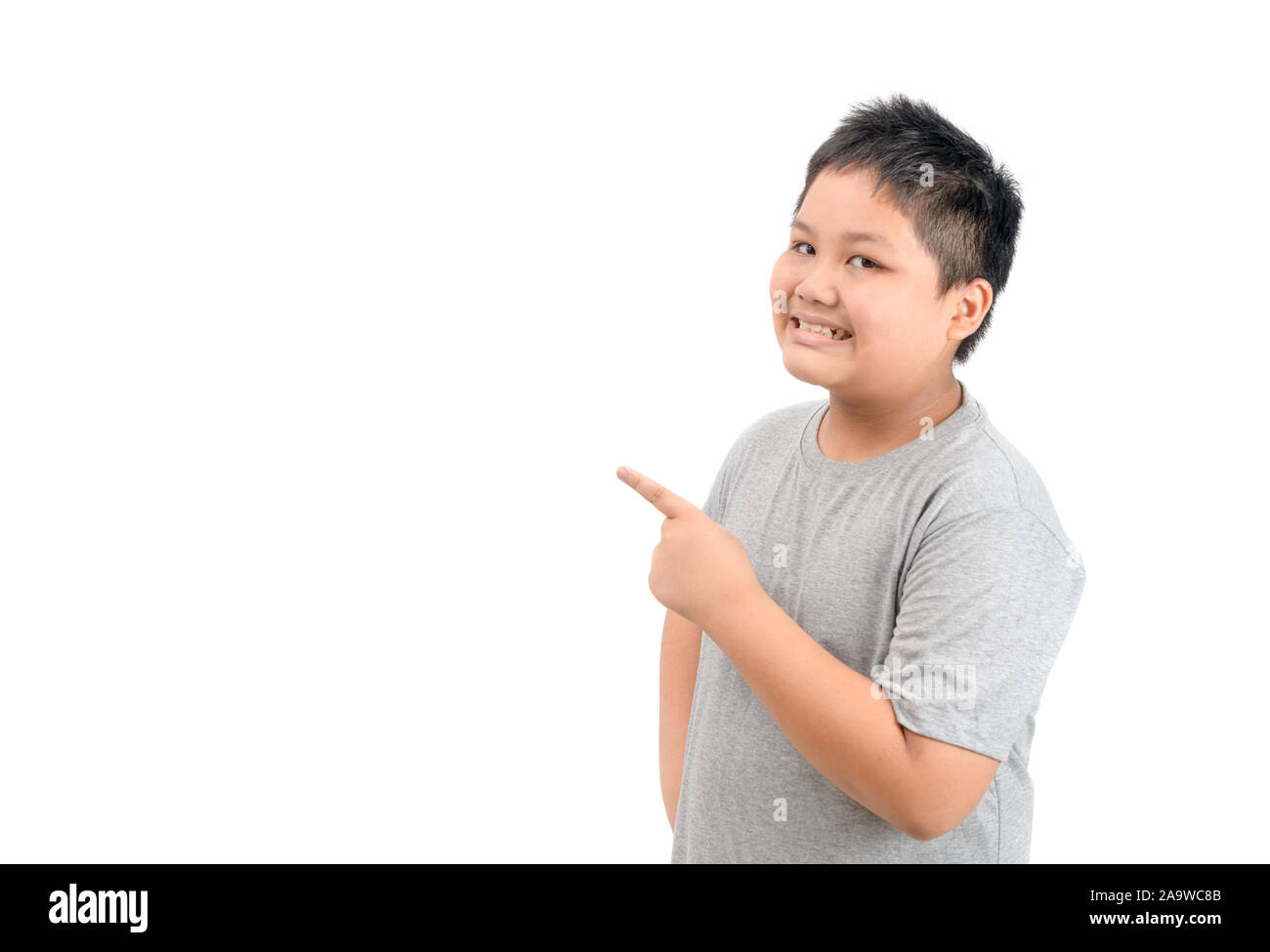 Happy fat boy pointing fingers isolated on white background, copy space ...