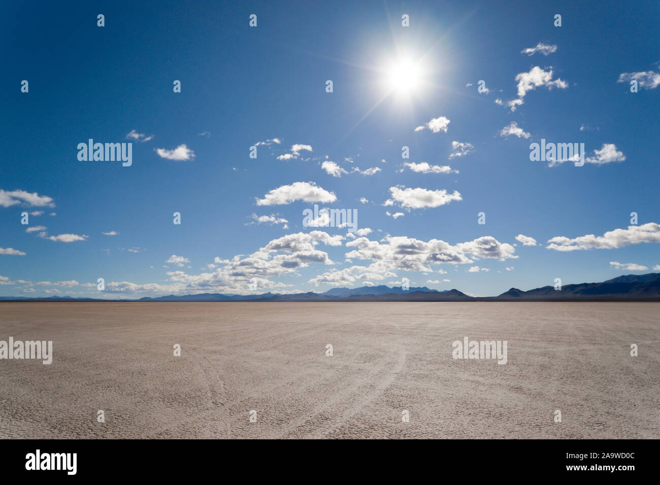 A dry lake bed and blue sky Stock Photo - Alamy