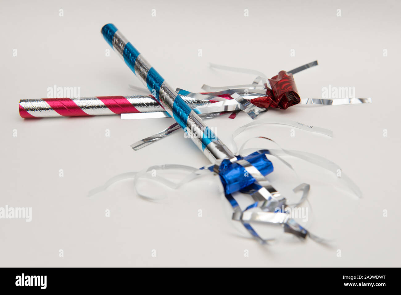 Isolated blue and red party blowers on white background Stock Photo - Alamy