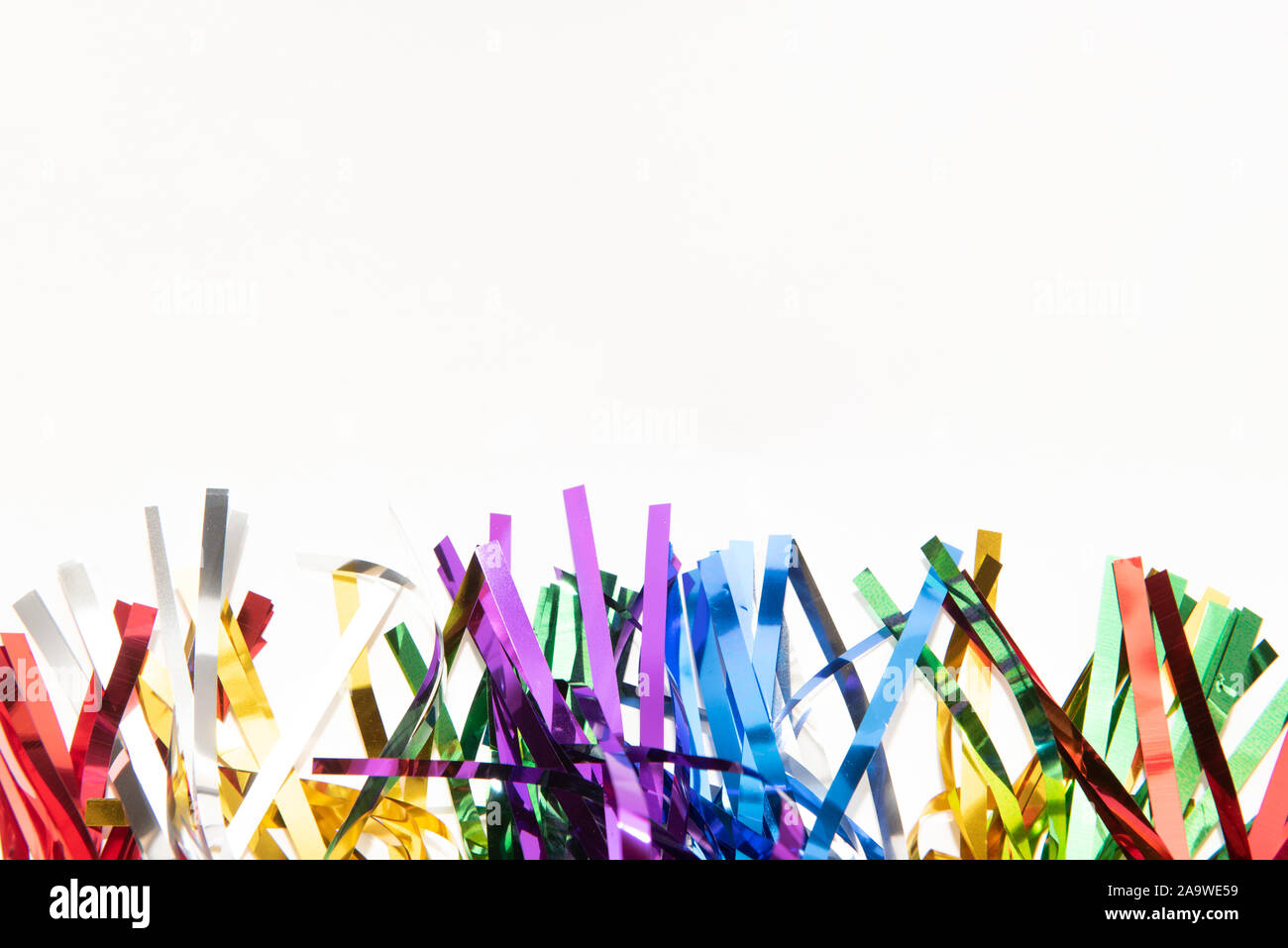 Isolated blue, pink, green, yellow and red party streamers on white ...