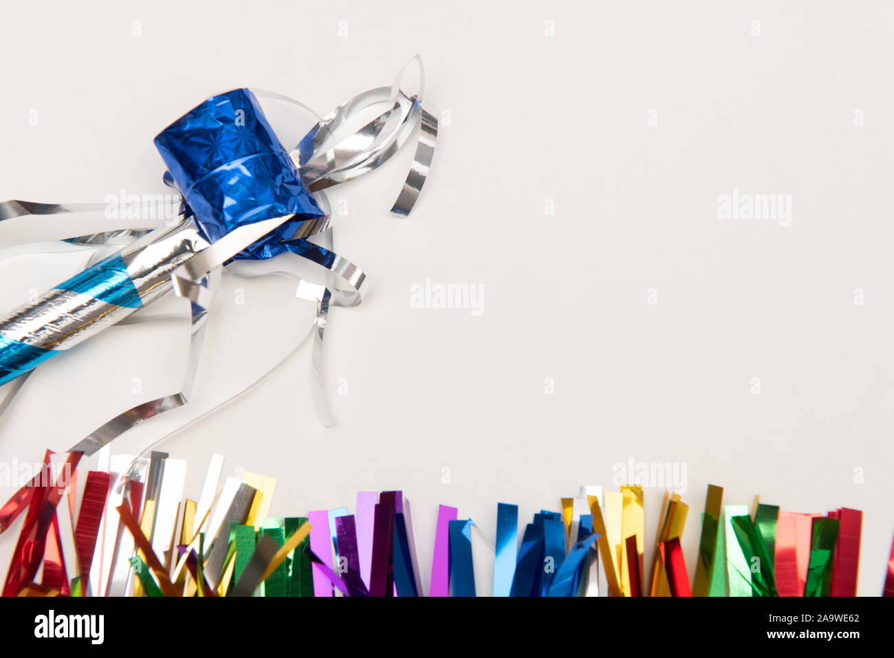Isolated blue, pink, green, yellow and red party streamers and blue ...