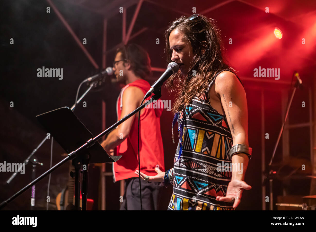 woman and man are singing and on the stage, male and female two singers ...