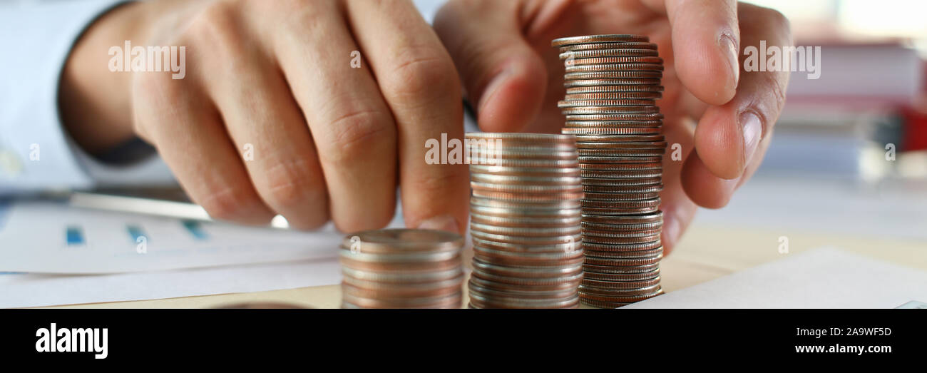 Hand businessman putting pin money Stock Photo - Alamy
