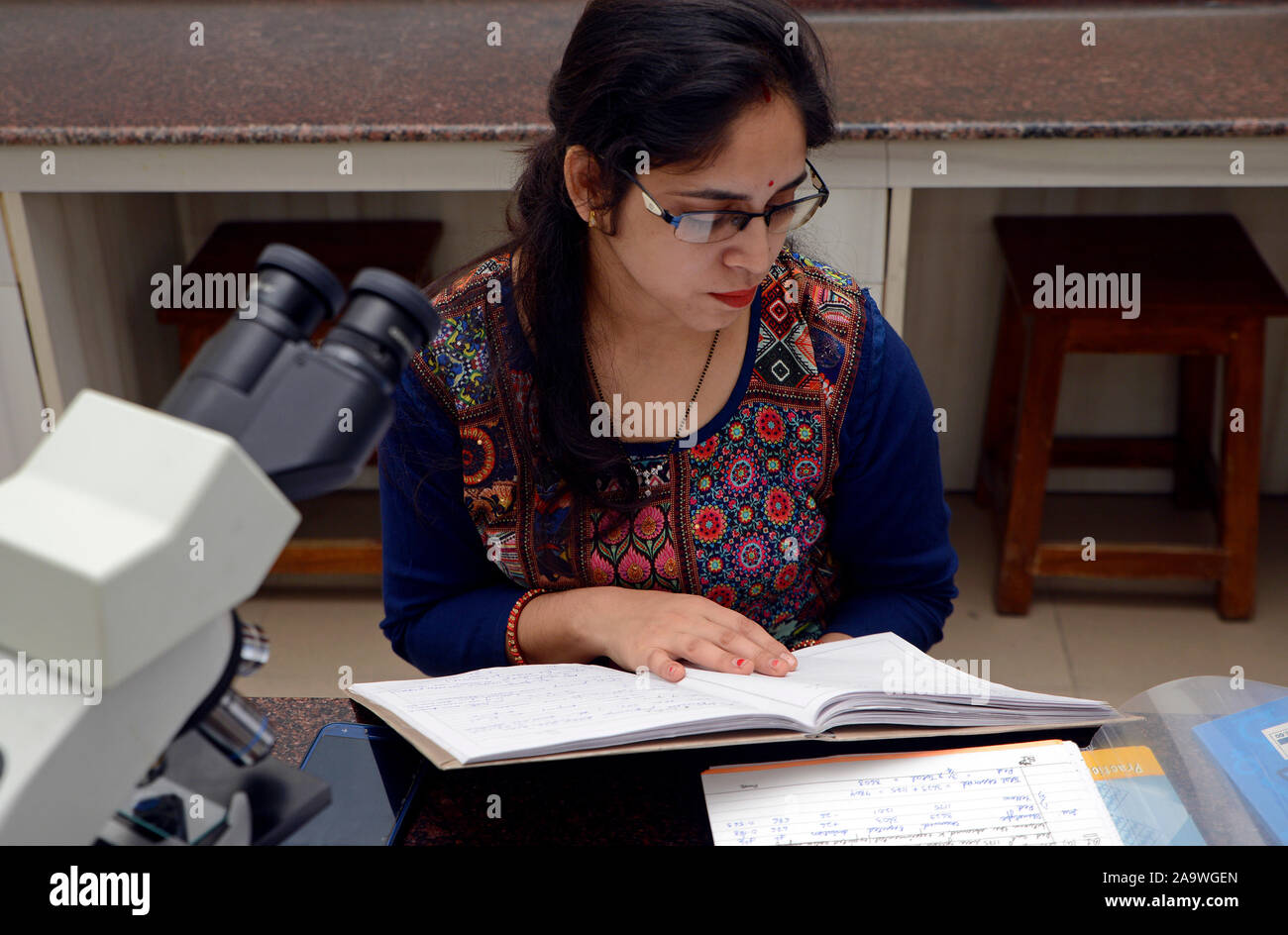 Female Student reading in Laboratory Stock Photo - Alamy