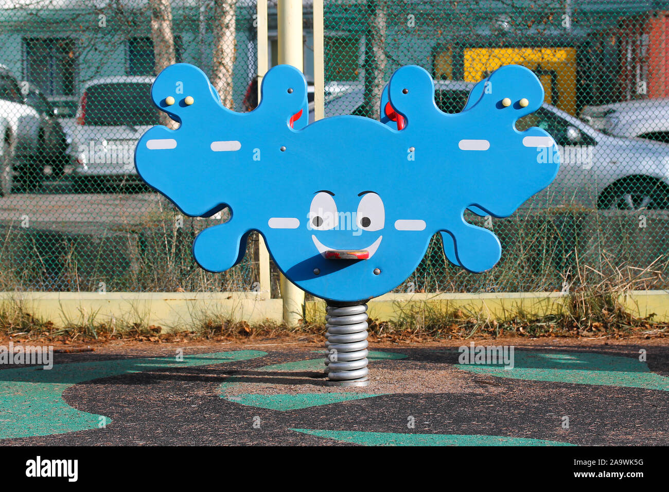 Spring swing with funny wooden octopus on kids playground. Blue swing ...