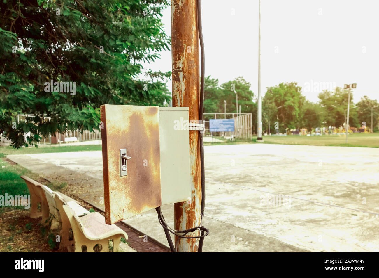 Old rusty electrical power control box on rusted electric pole in the ...