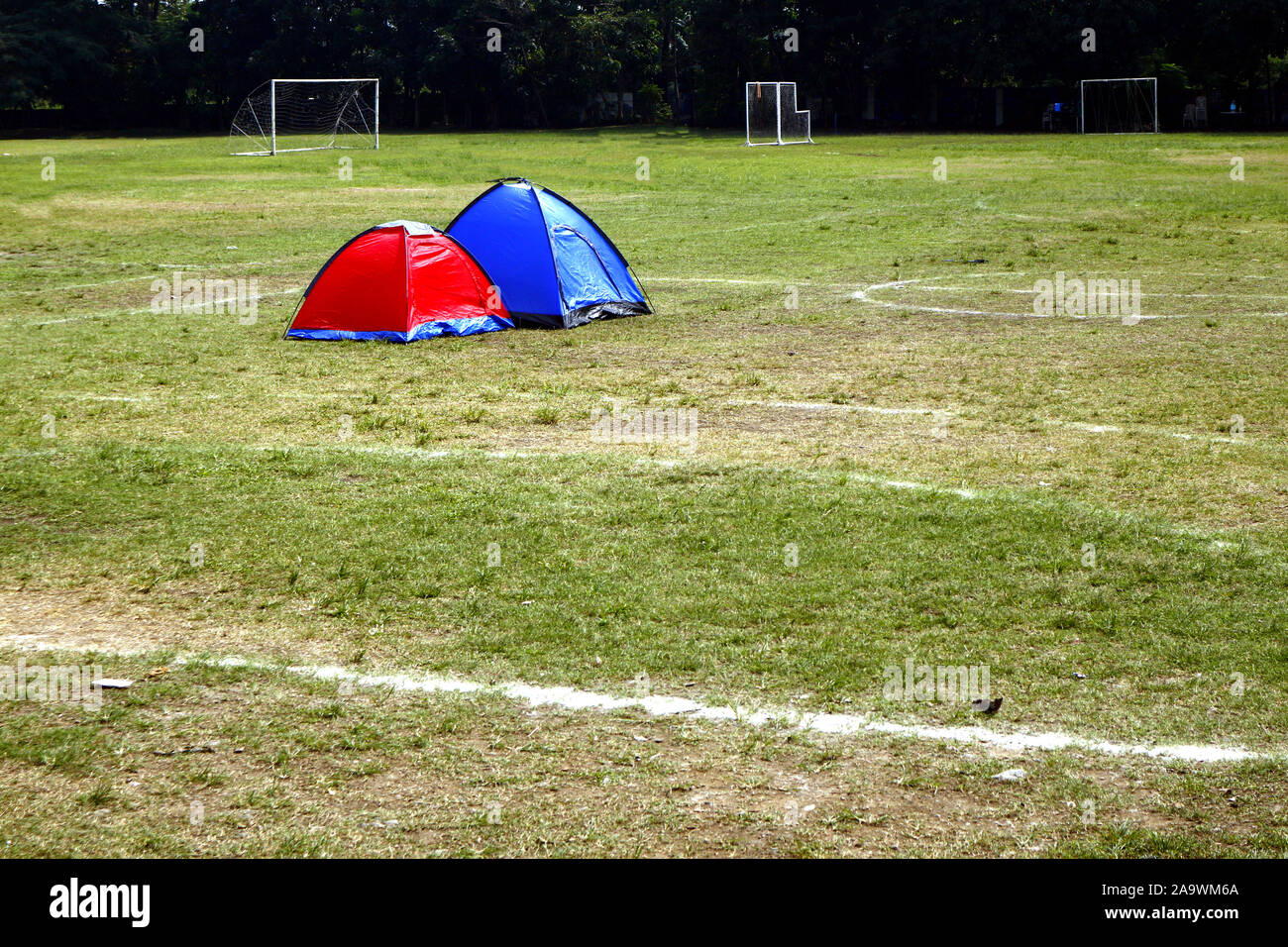 Photo of red and blue camping tent on a grass field Stock Photo - Alamy