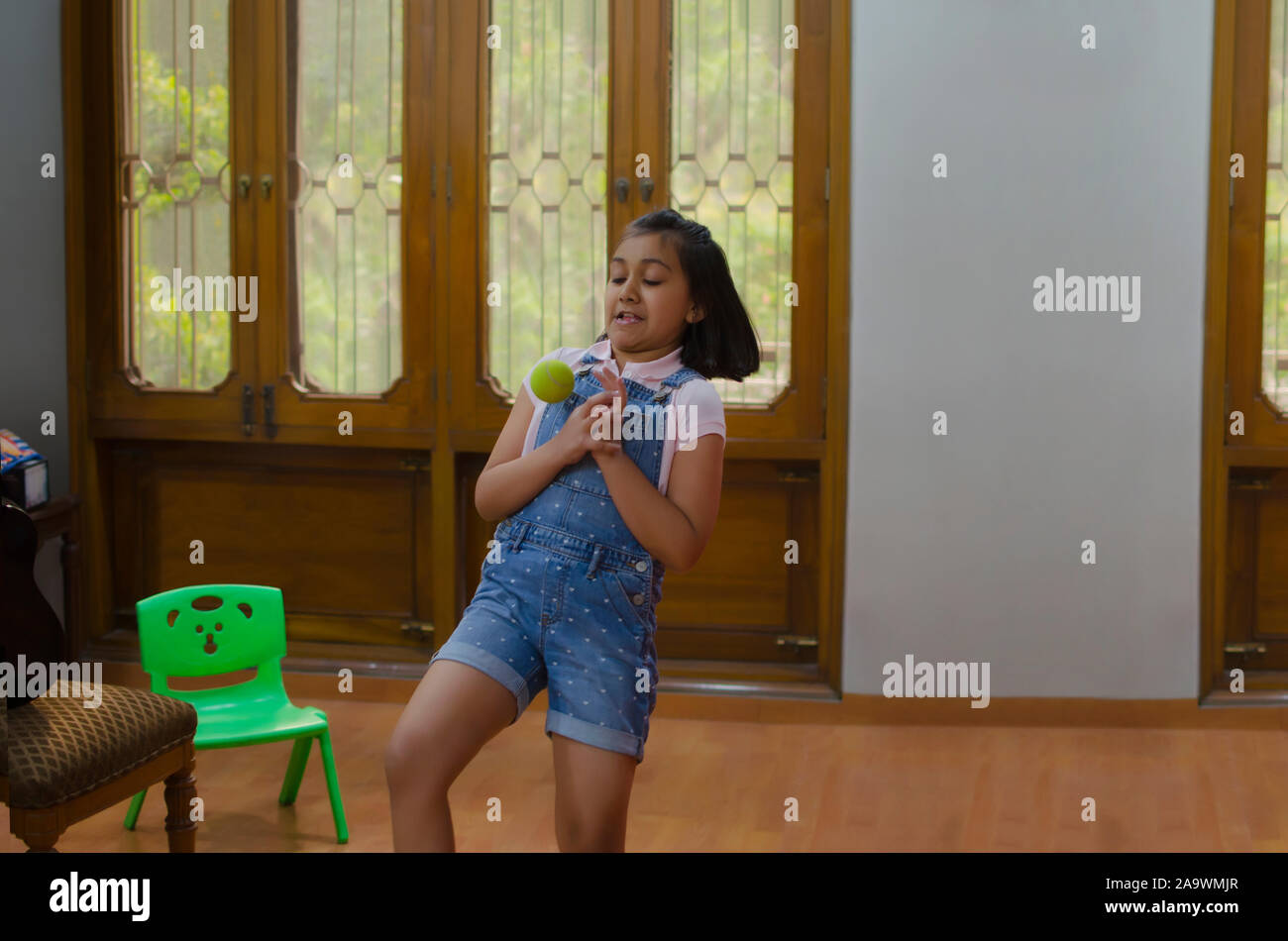 Young girl trying to catch a ball Stock Photo - Alamy