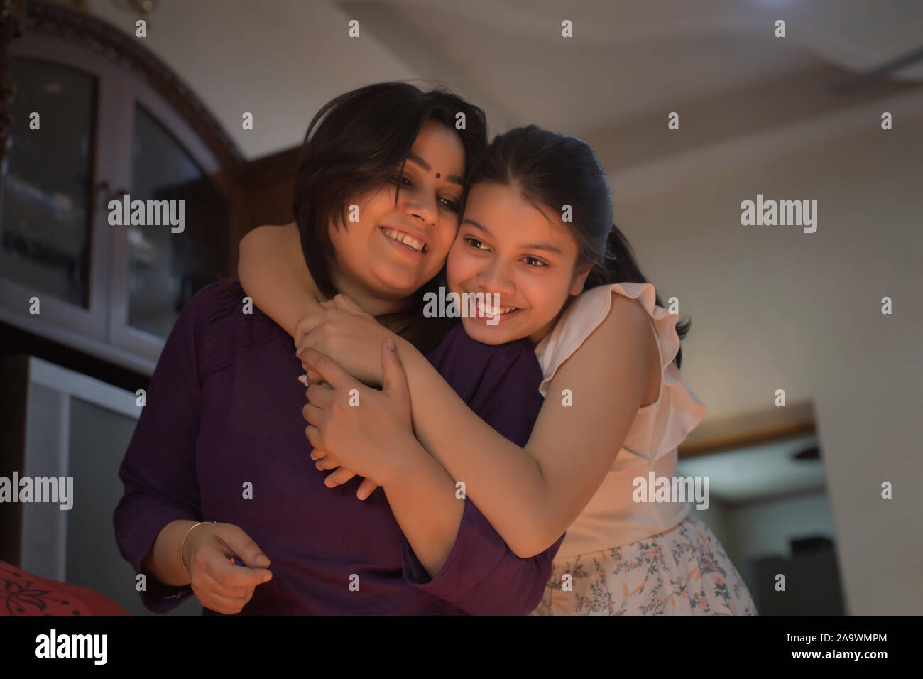 daughter hugging her mother Stock Photo - Alamy