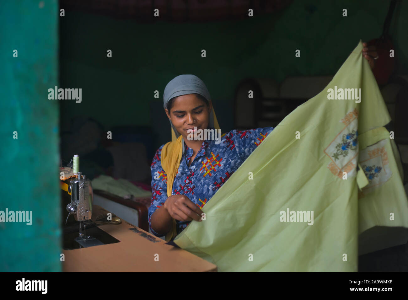 Young girl holding a cloth while stitching Stock Photo - Alamy