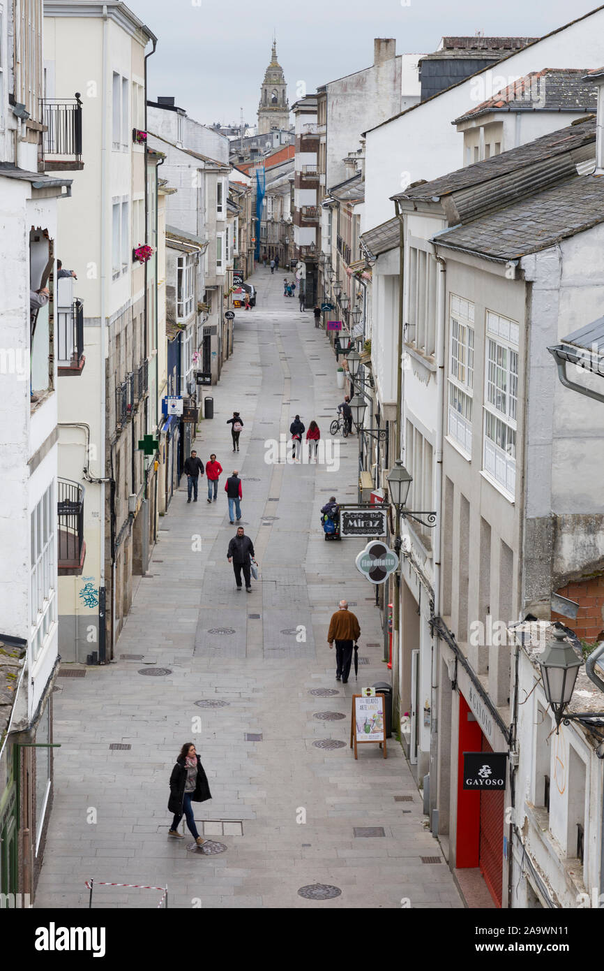 Locals walk along Rúa Nova inside the Casco Histórico in Lugo, Spain ...