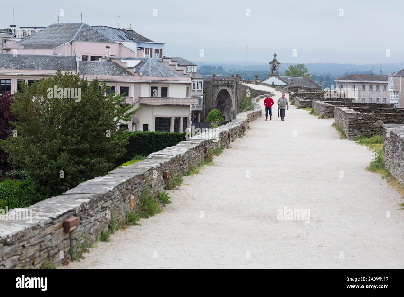 Two men walk along the footpath on the Roman Walls of Lugo in Lugo ...