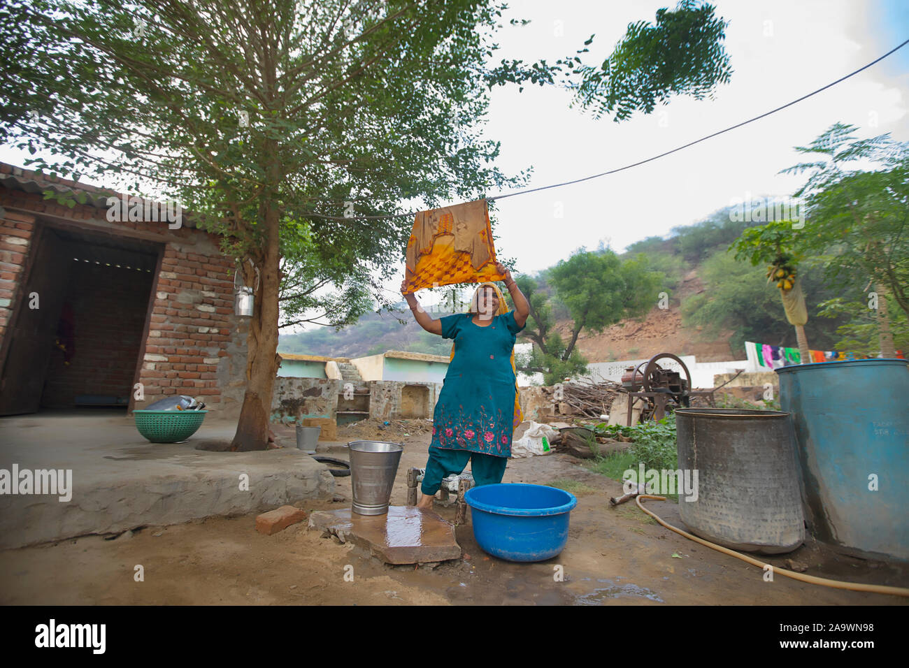 woman hanging clothes on wire Stock Photo - Alamy