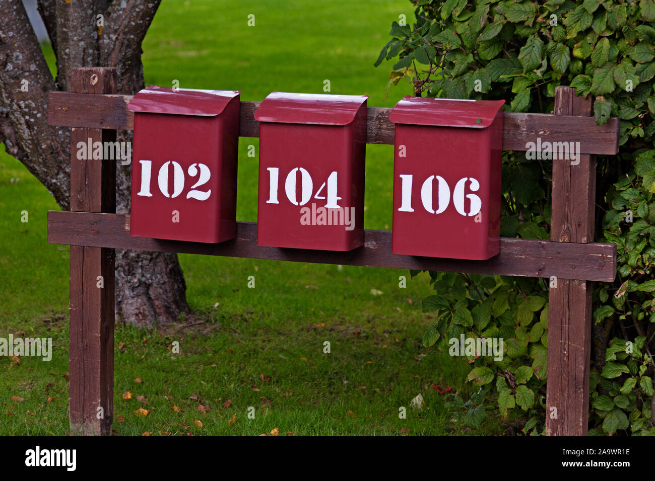 three red mailboxes in a row with white text on Roback Stock Photo - Alamy