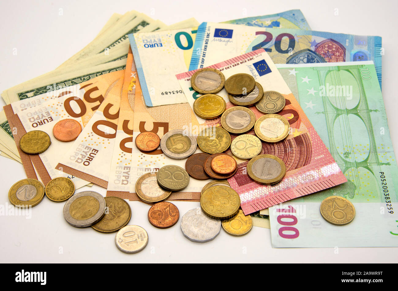 Paper euros of different denominations and coins of different countries ...