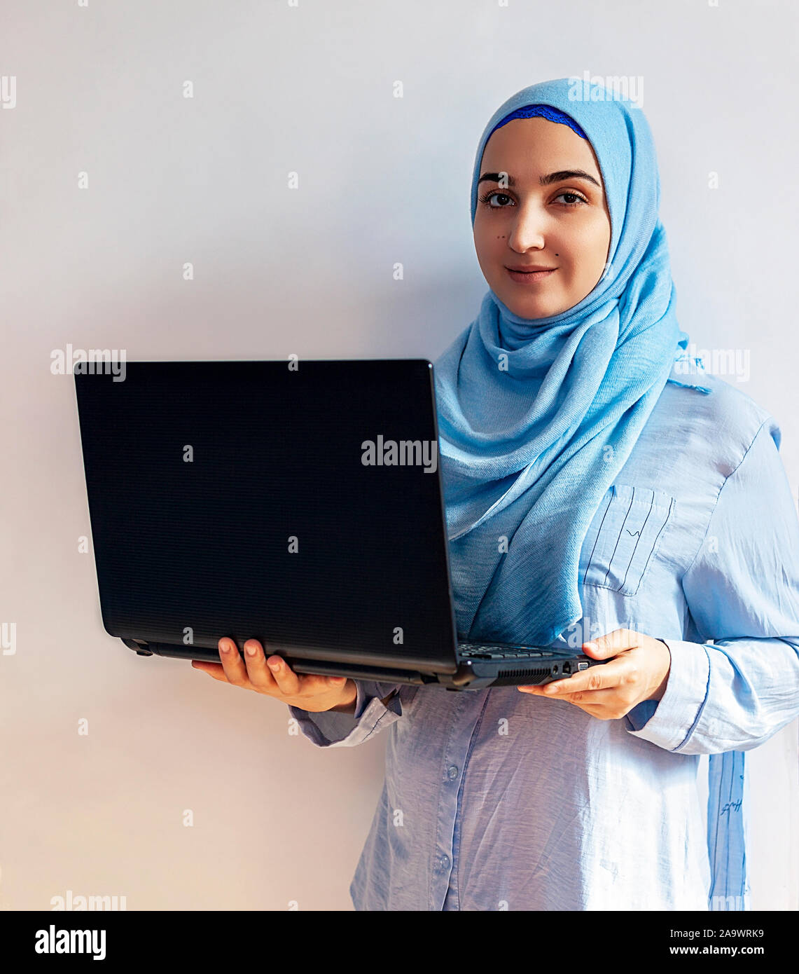 Businesswoman in hijab having a video chat on the laptop. Cute Muslim ...