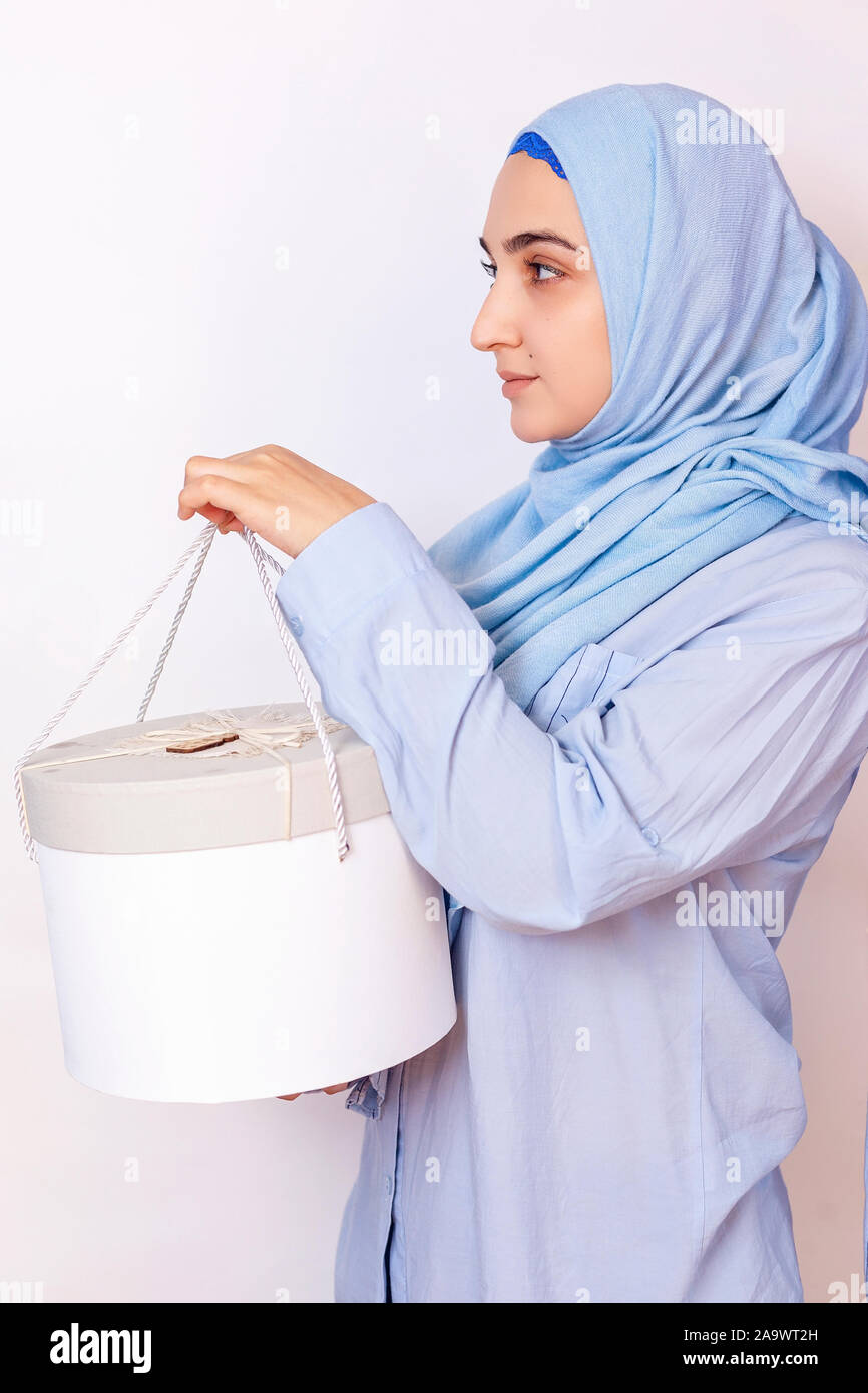 Muslim woman giving or receiving a gift on an Islamic holiday. Cute and ...