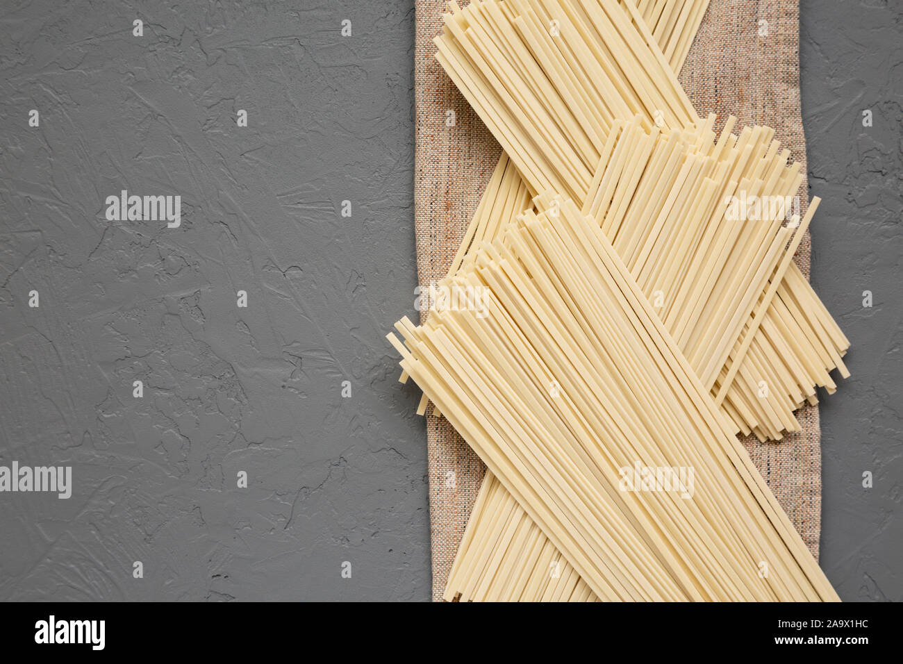 Uncooked dry white Ramen noodles over gray background, overhead view ...